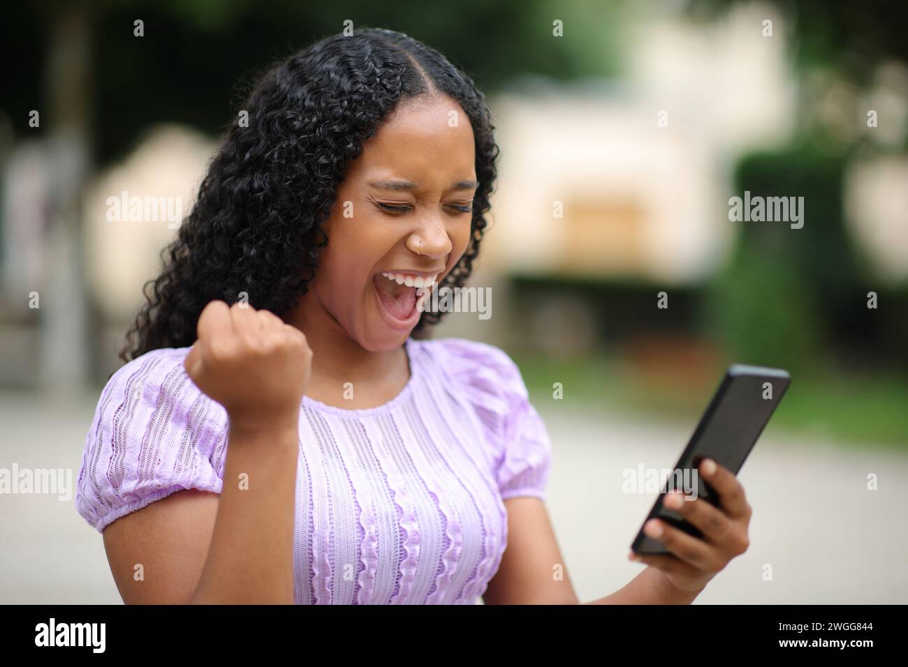 African woman mobile phone excited hi-res stock photography and images - Alamy