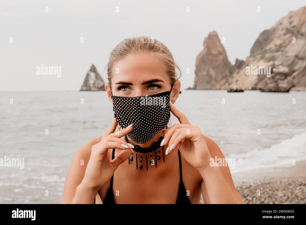 Woman travel portrait. Happy woman with long hair poses on a red ...