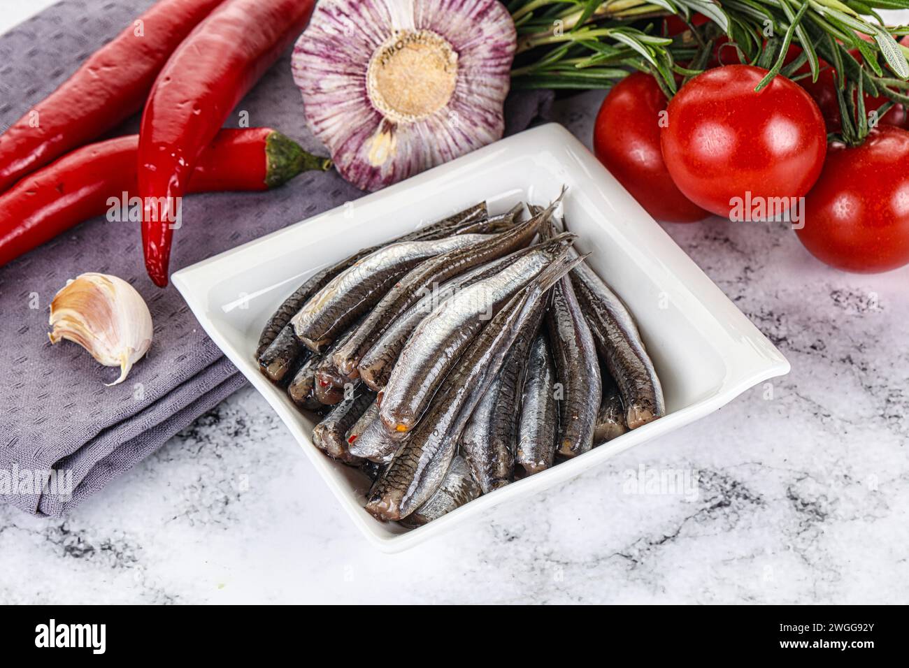 Pickled anchovy fish in the plate Stock Photo - Alamy