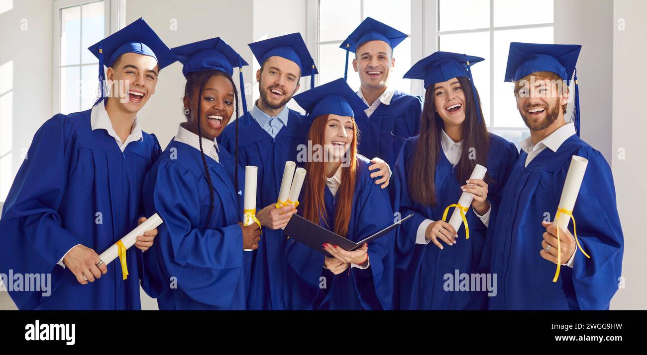 Group portrait of students graduation ceremony, happy young diverse ...