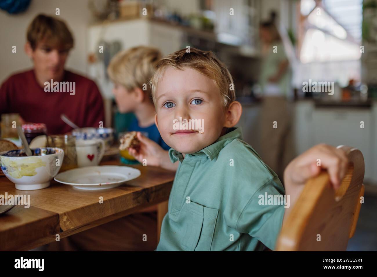 Family eating breakfast together in home kitchen. Healthy breakfast or ...