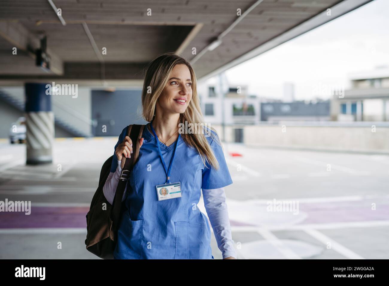 Nurse, doctor walking across hospital parking lot, going home from work ...