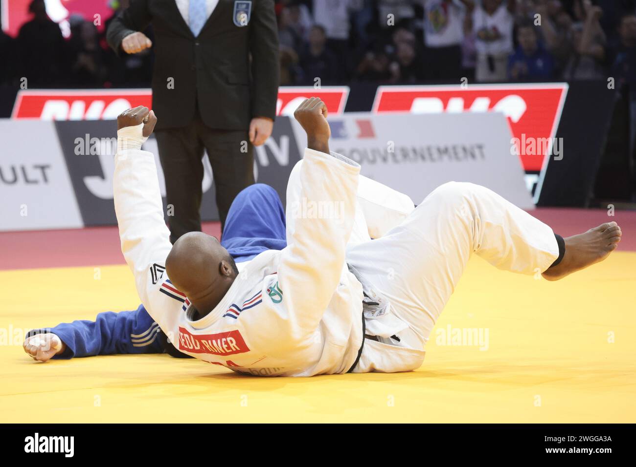 Teddy Riner of France (white) celebrates winning against Minjong Kim of ...