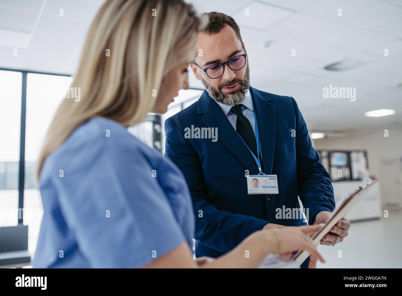 Pharmaceutical sales representative talking with doctor, presenting new ...