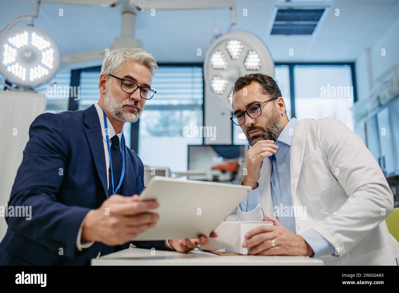 Pharmaceutical sales representative presenting new medication to doctor ...