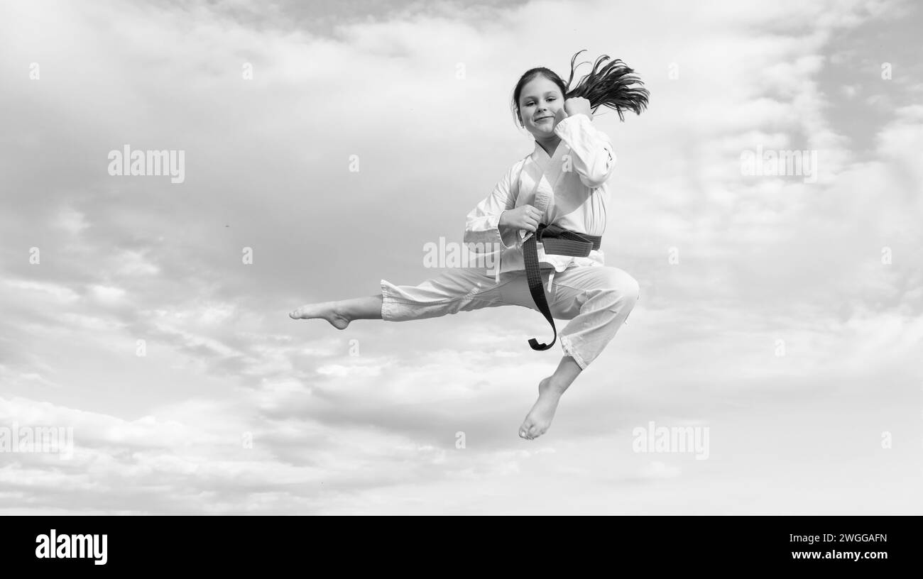 judo concept. teen girl practicing judo. girl judo fighter jumping on sky background Stock Photo ...