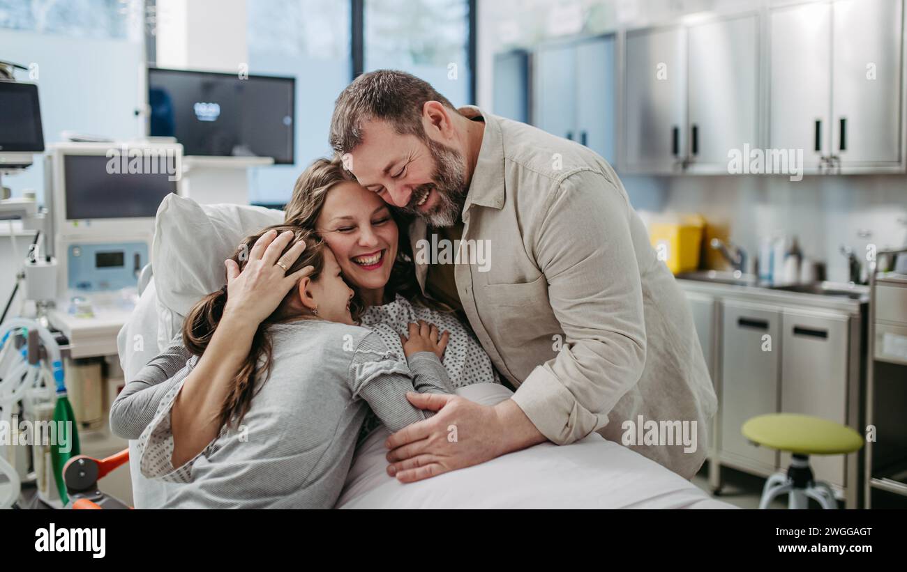 Father and daughter visiting mother in hospital after surgery ...