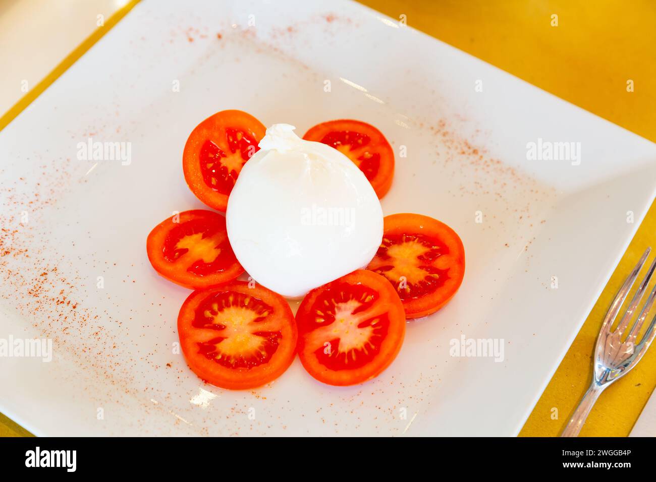 Italian snack Buratta with tomatoes Stock Photo - Alamy