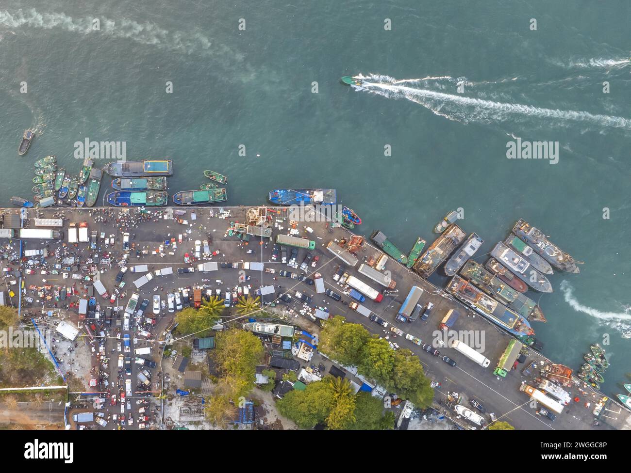 Aerial photo shows the bustling seafood market at a fishing port wharf ...