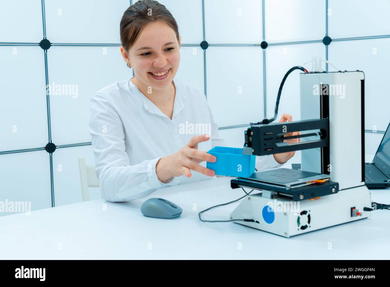 young female student using 3D printer in school laboratory Stock Photo ...