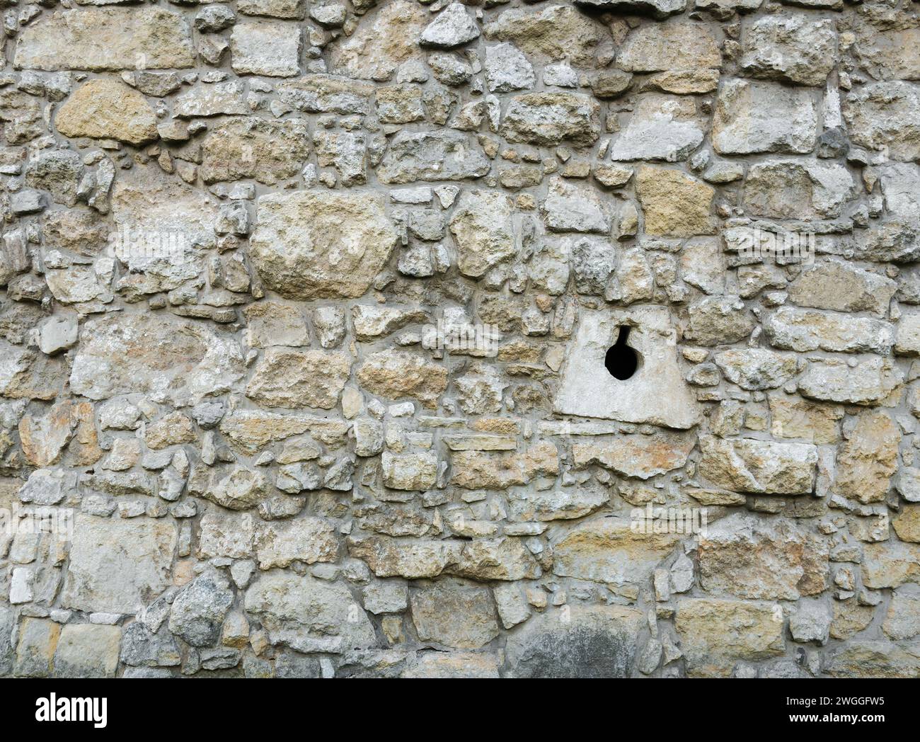 Medieval stone wall with loophole. Background Stock Photo - Alamy