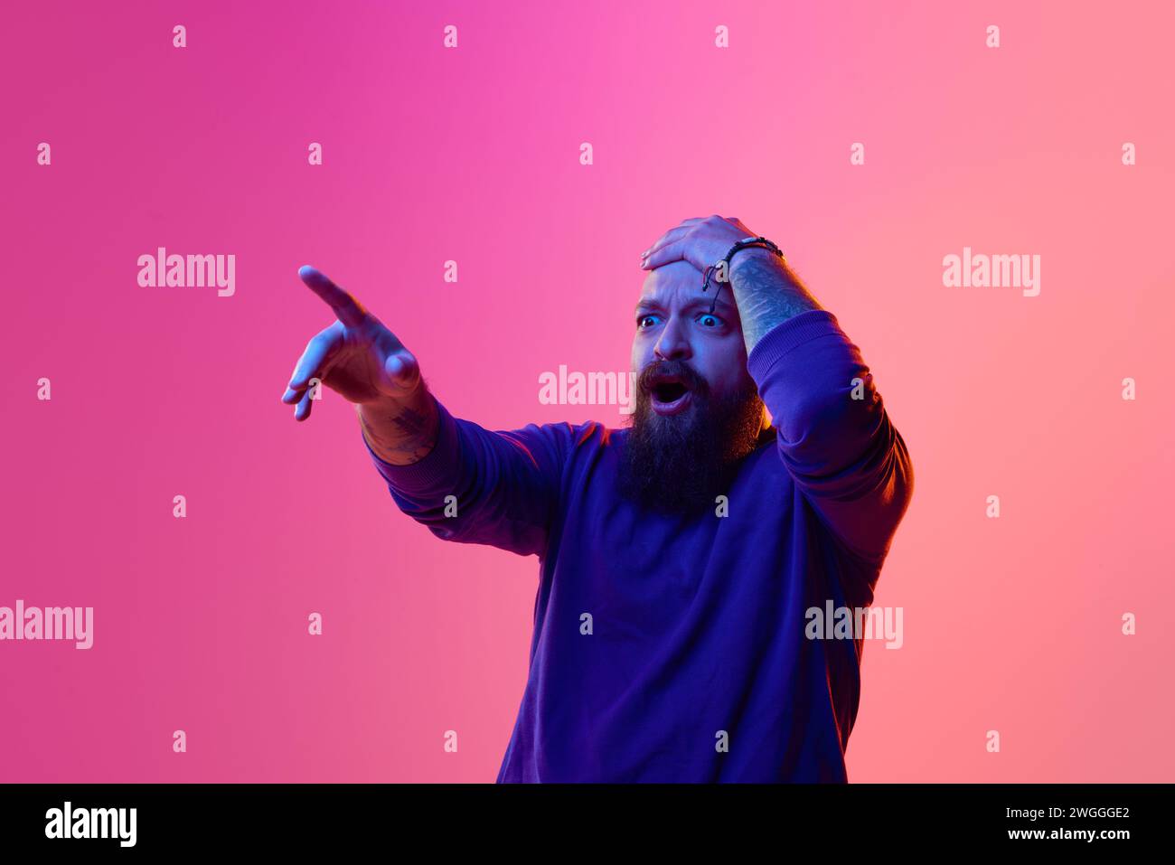 Wow. Bearded bald man in his 30s standing with wide open eyes, mouth, showing shocked face and ...