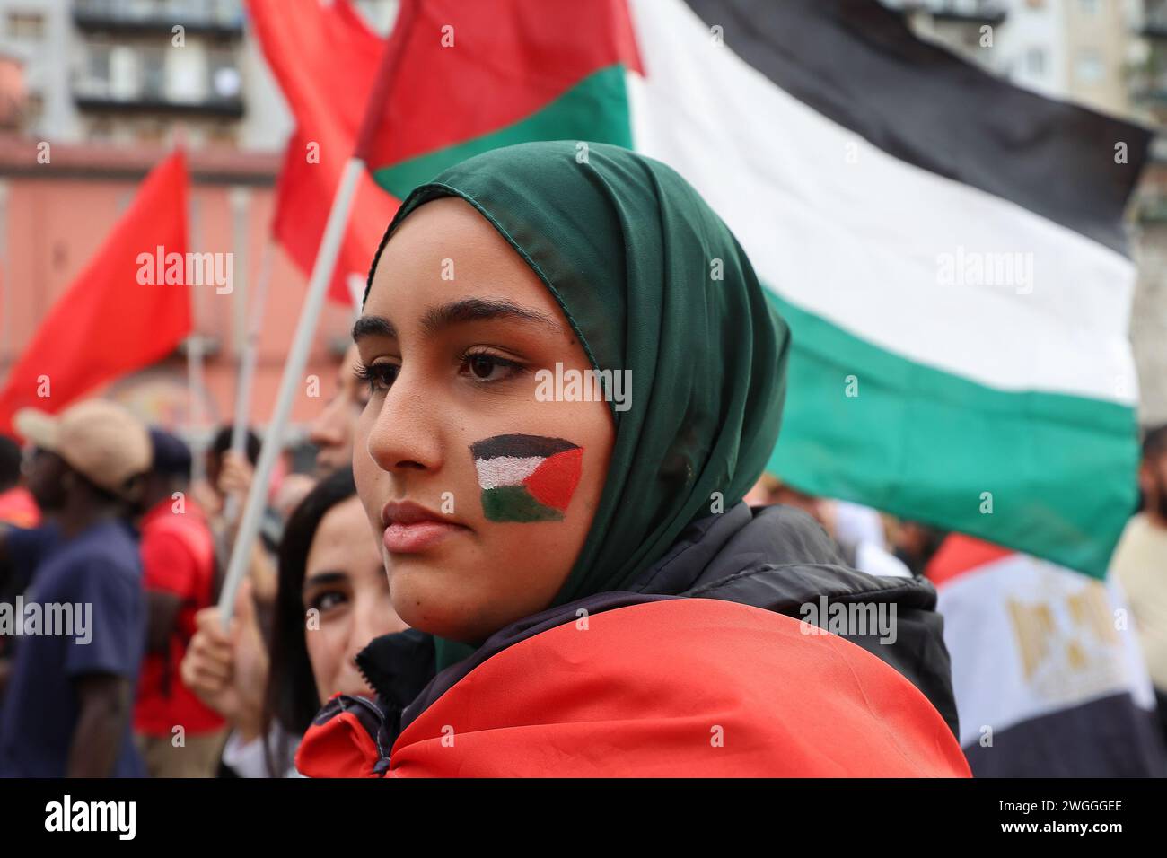 A woman with a Palestinian flag painted on his face during the ...