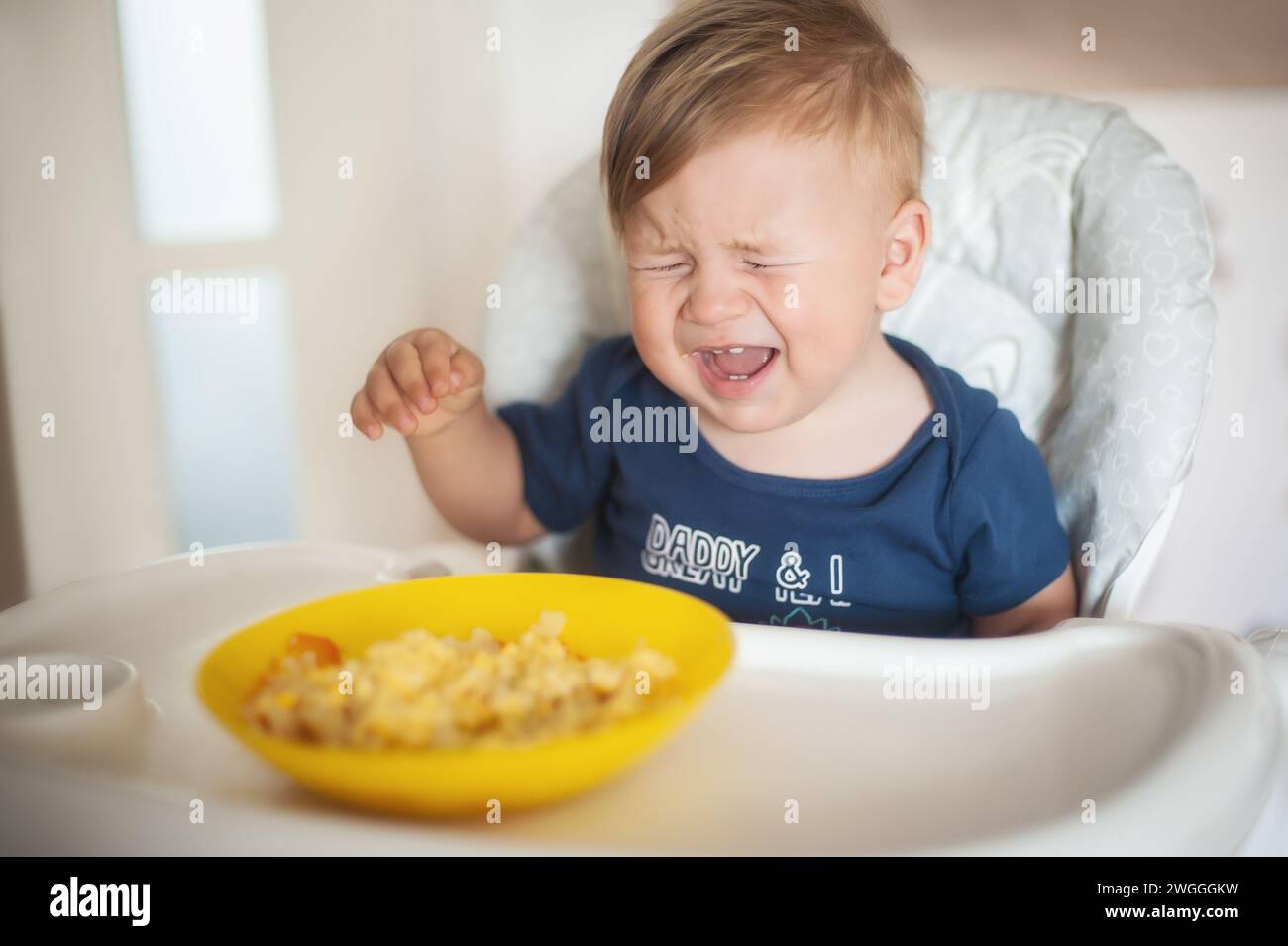 Crying baby boy sitting on chair hi-res stock photography and images ...