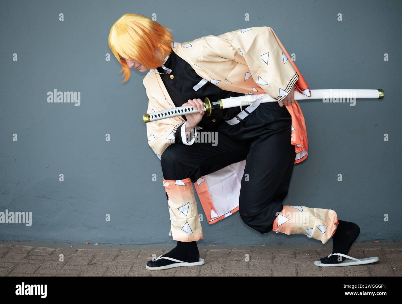A cosplayer dressed as a samurai with orange hair Stock Photo - Alamy