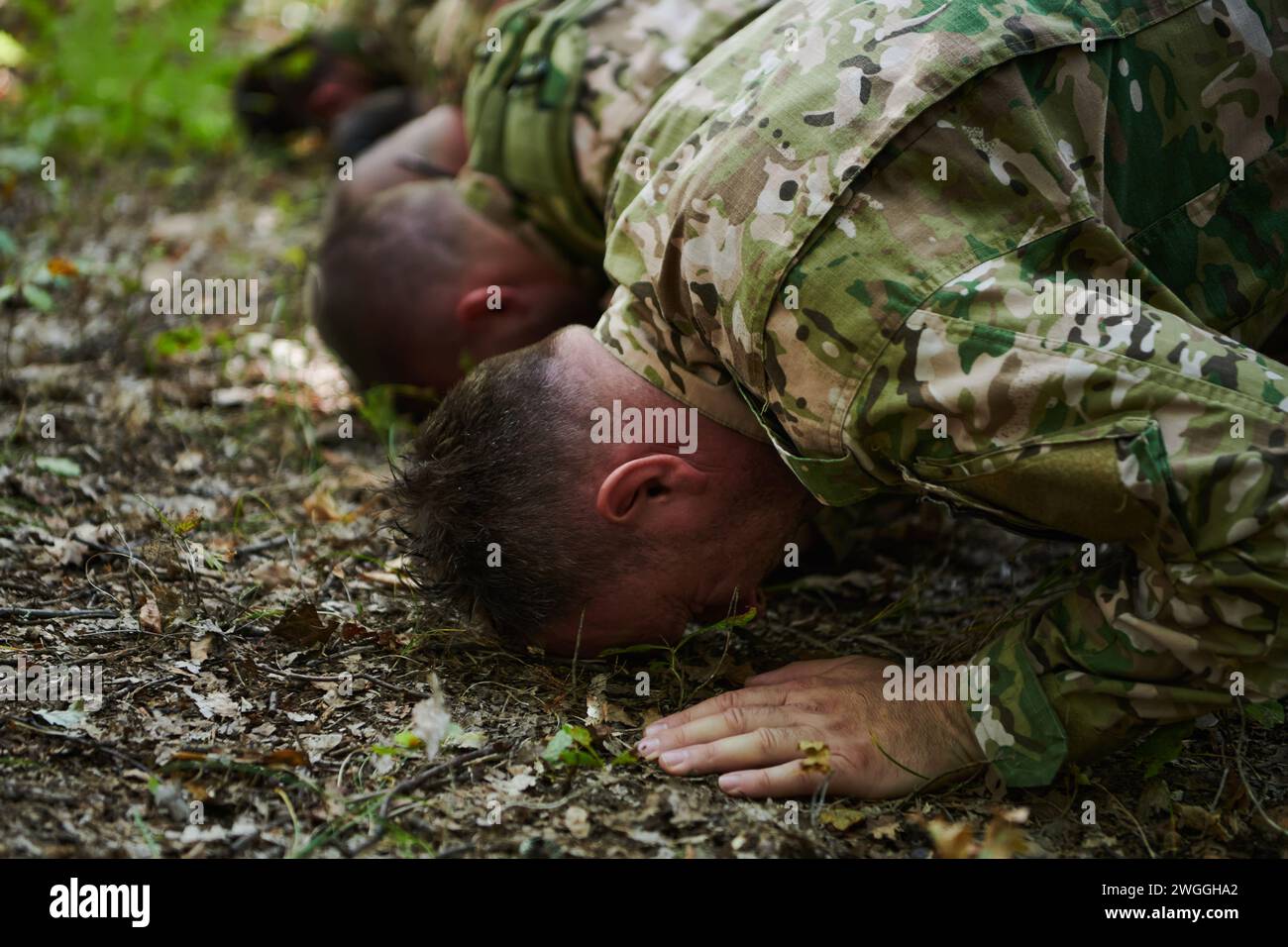 A dedicated group of soldiers engages in Islamic prayer amidst the ...