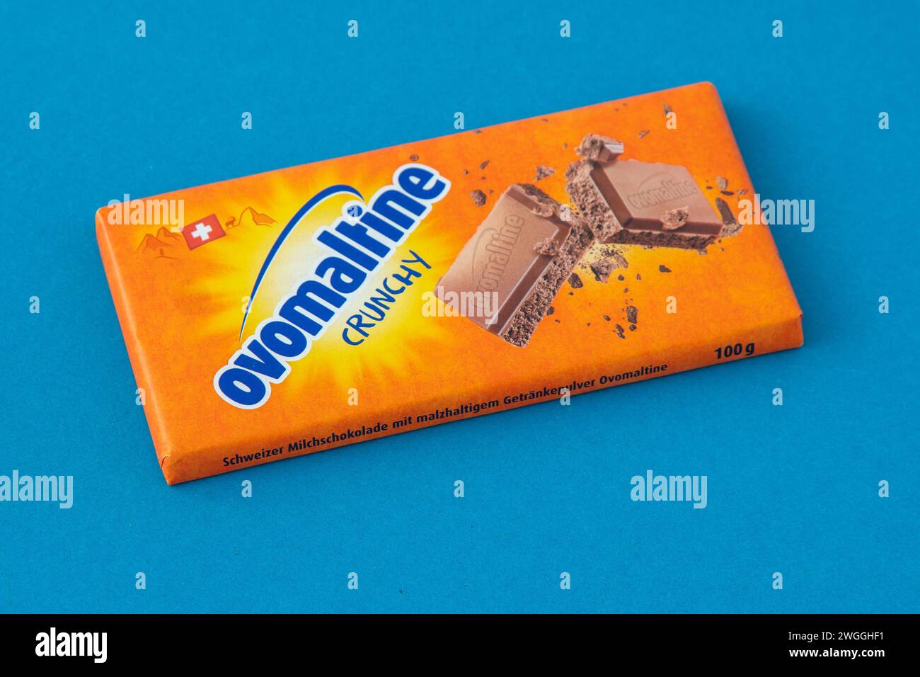 Swiss chocolate from Ovomaltine. Tiles in orange packaging. Sweetness ...