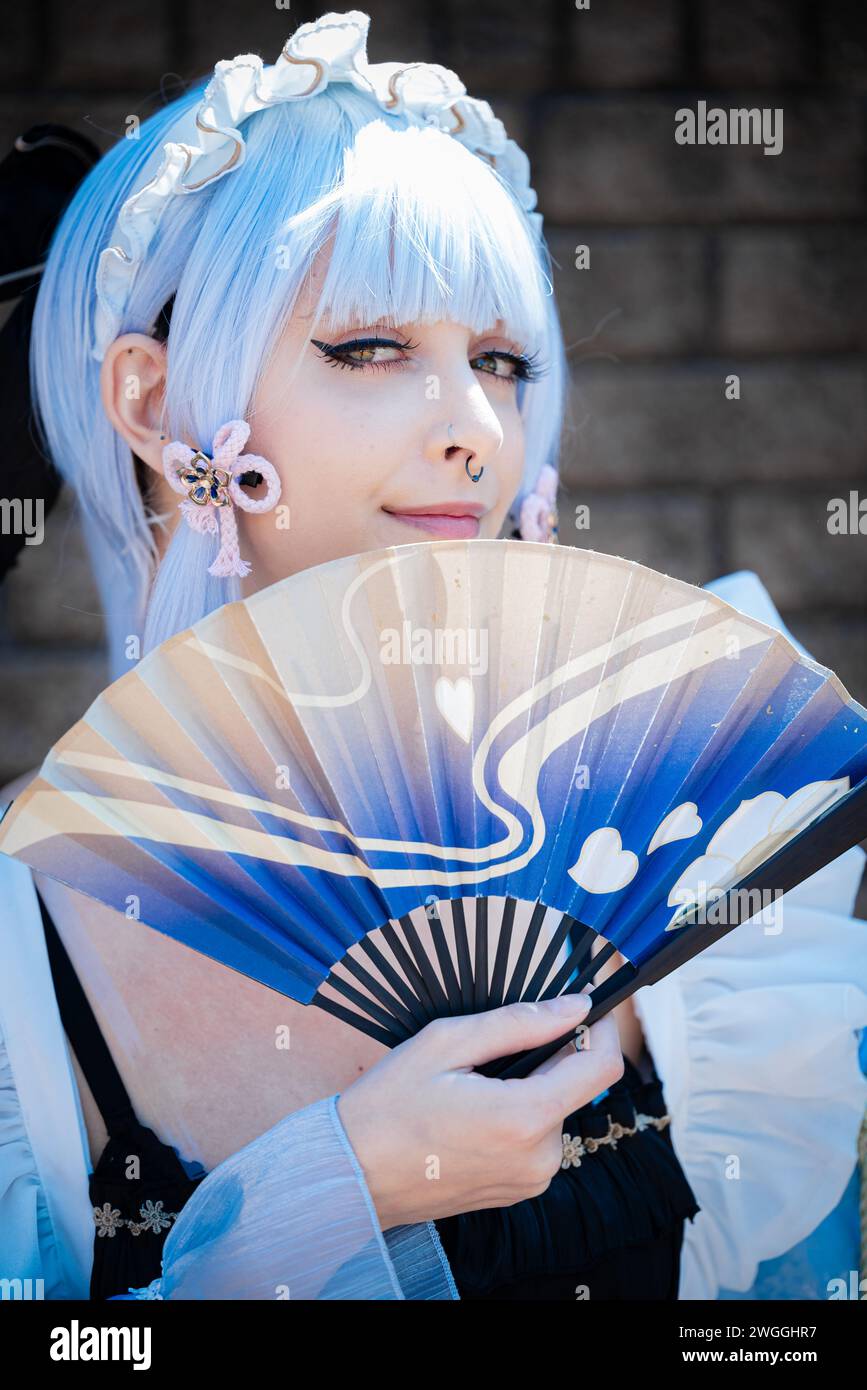 A female cosplayer in a vintage blue dress with blue hair Stock Photo ...