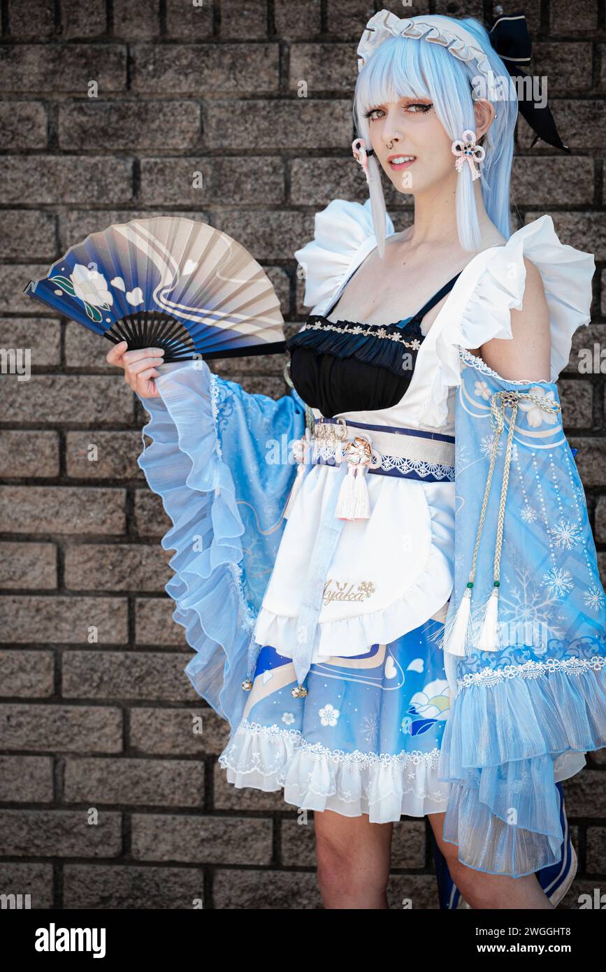 A female cosplayer in a vintage blue dress with blue hair Stock Photo ...