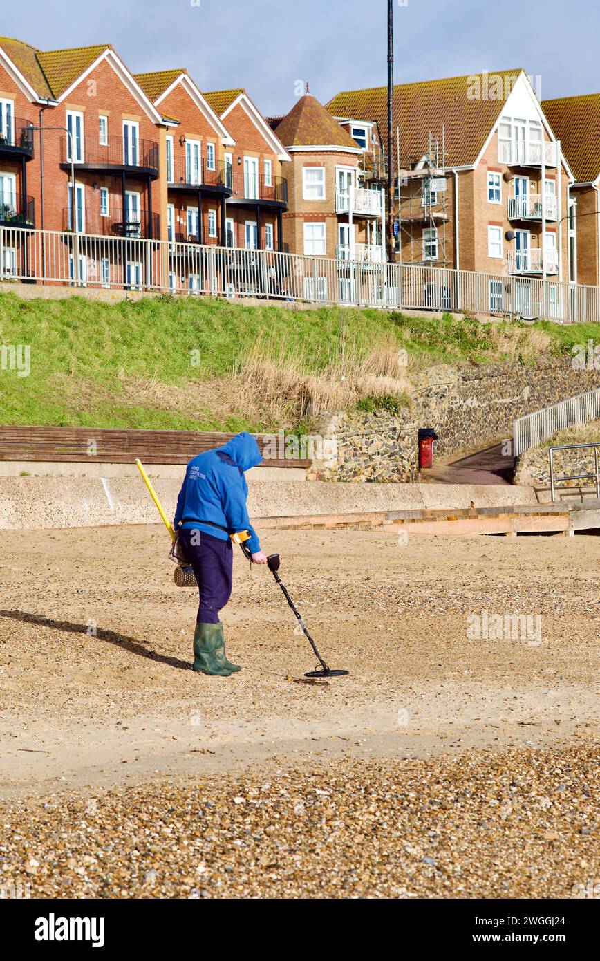 Metal detecting along the beach at Clacton on Sea Stock Photo - Alamy