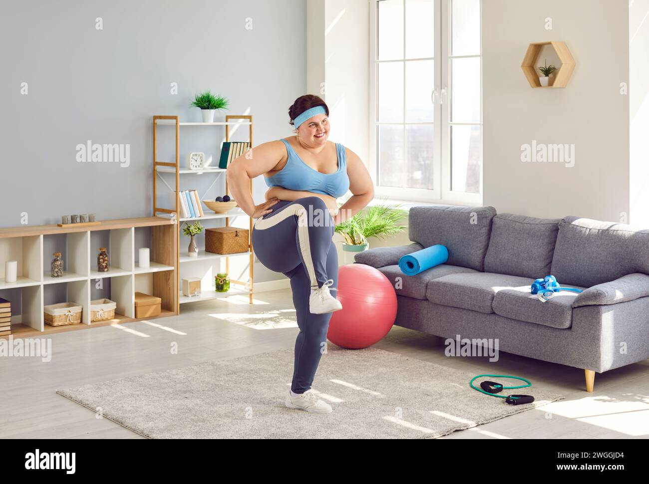 Cheerful chubby, overweight woman doing fitness exercise at home Stock ...