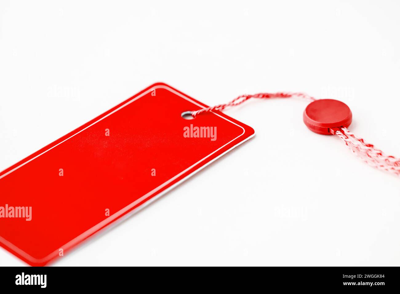 Red luggage label, copy space. Blank price textured sell tag with rope ...