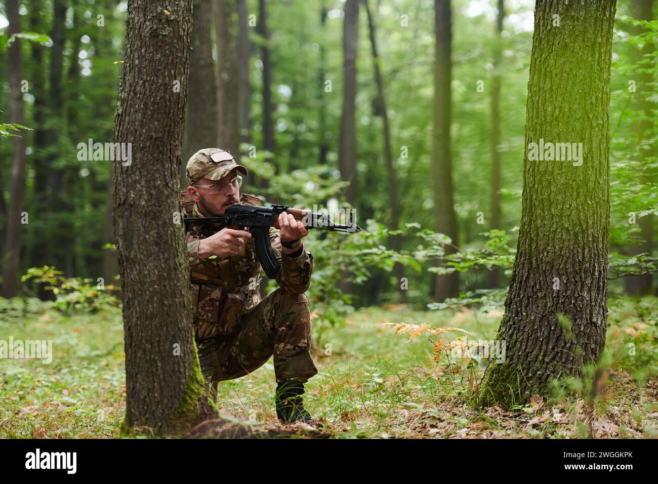 An elite soldier, camouflaged and stealthily navigating through ...