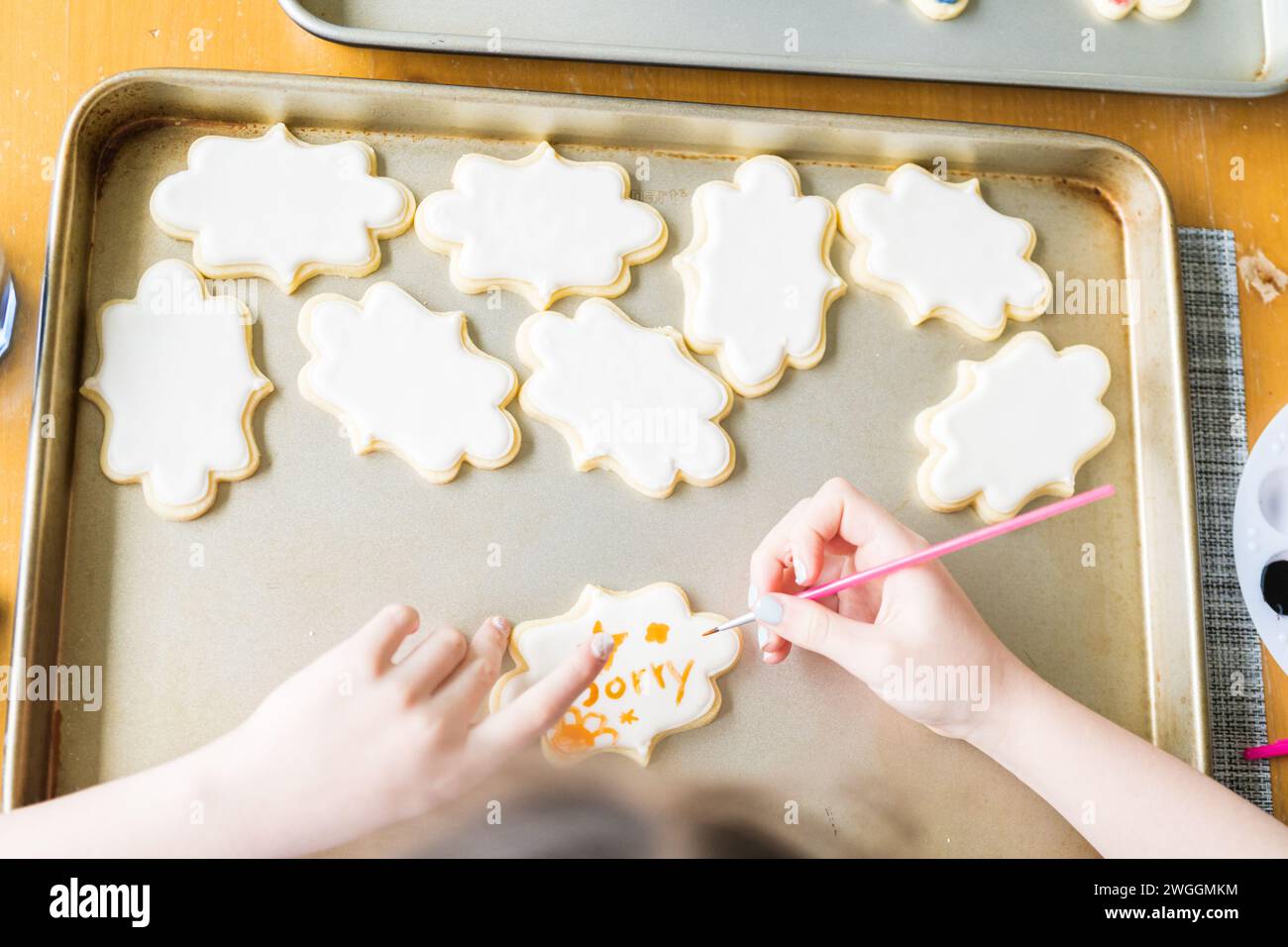 Little Girl Spells 'Sorry' on Iced Sugar Cookies Stock Photo - Alamy