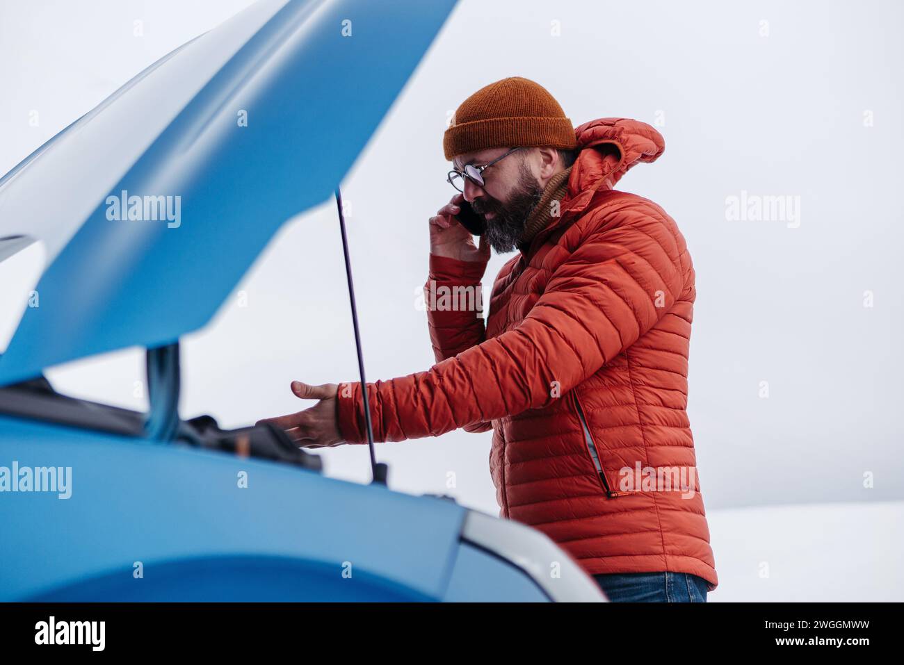 Angry man standing by electric car, battery run out of power before ...