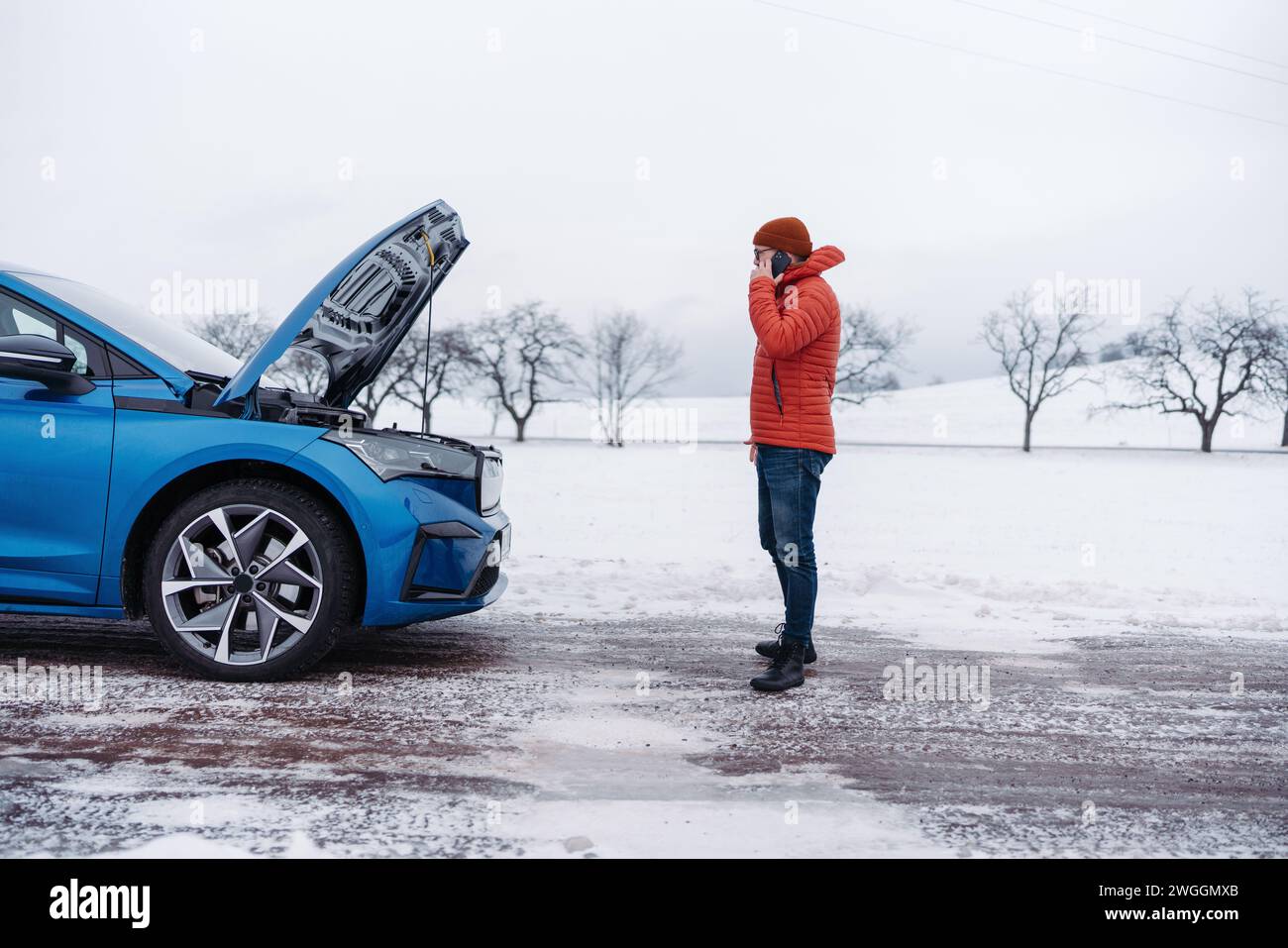 Angry man standing by electric car, battery run out of power before ...