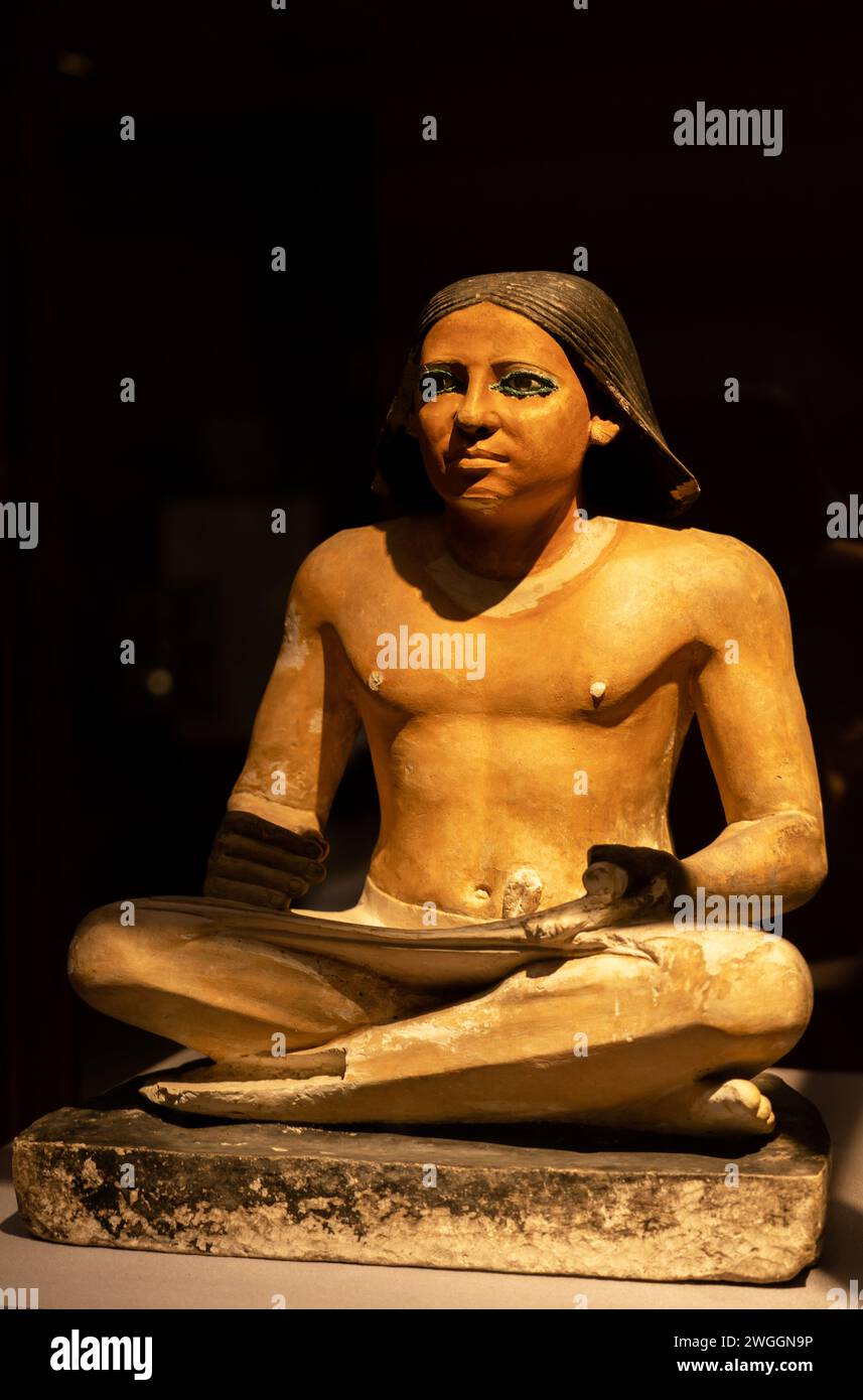 Egyptian figurine of a seated scribe Stock Photo - Alamy