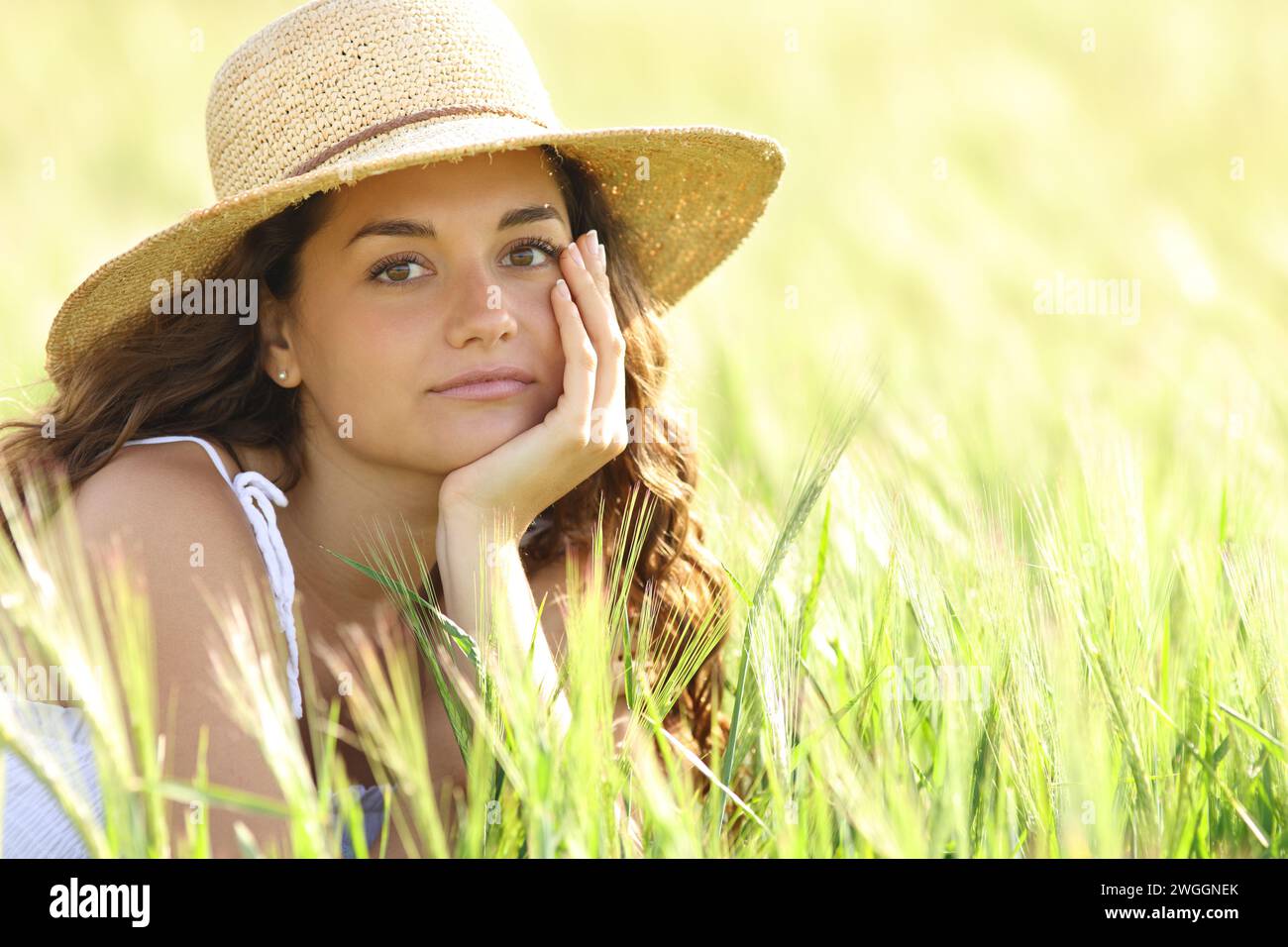 Portrait of a serious woman wearing pamela hat looking at you in a ...