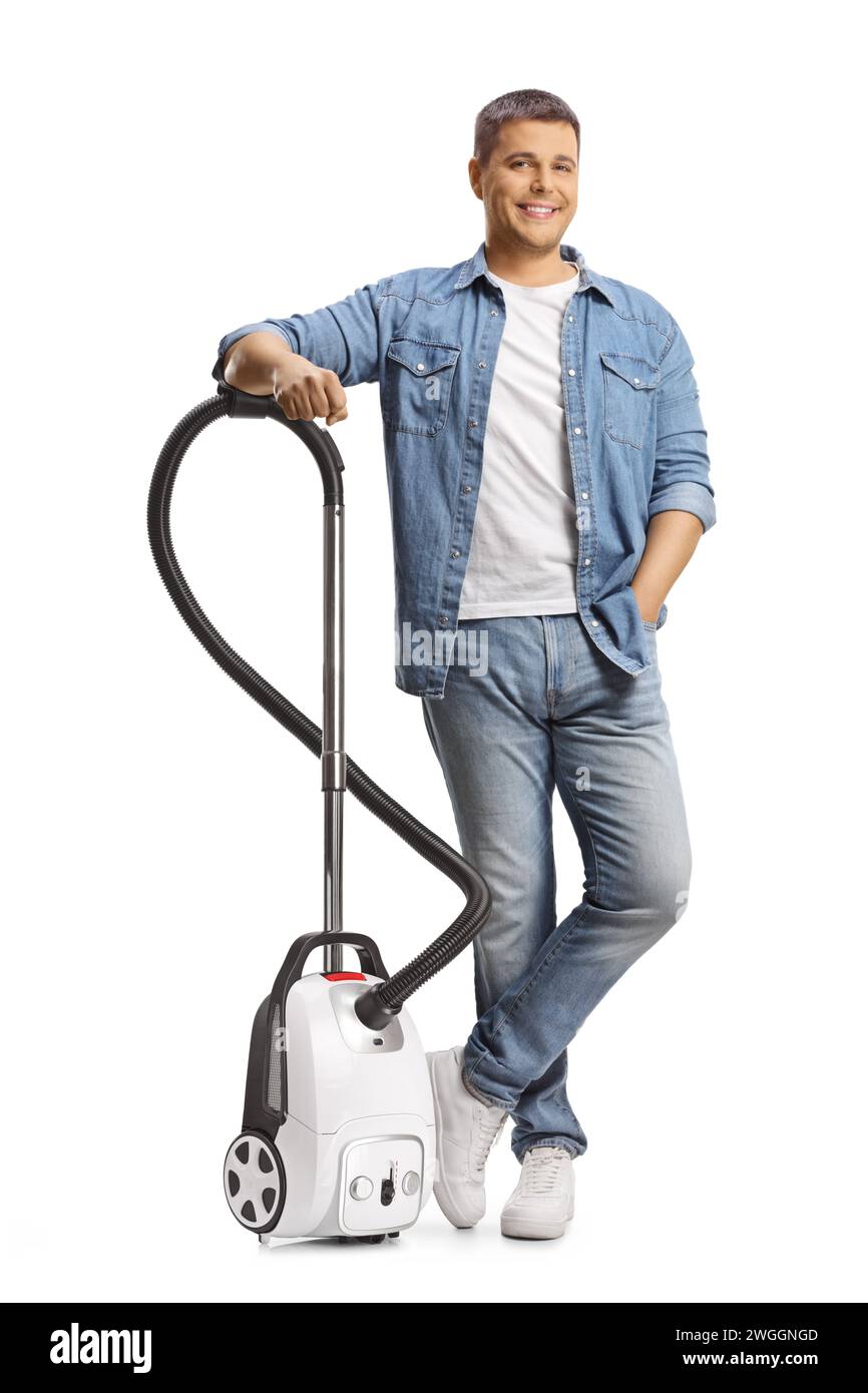 Man smiling and leaning on a vacuum cleaner isolated on white ...