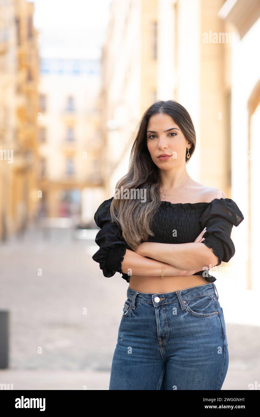 Woman staring camera arms folded hi-res stock photography and images ...