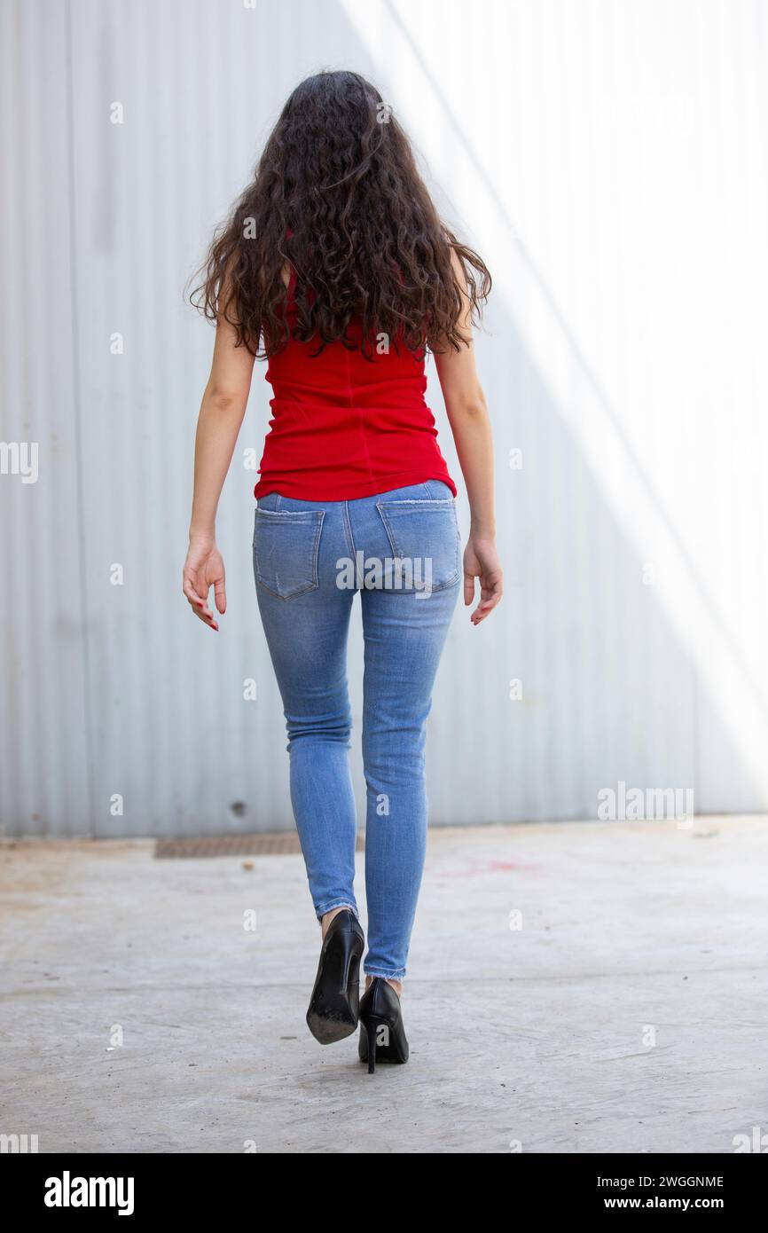 Full length rear view woman walking away outdoors Stock Photo - Alamy