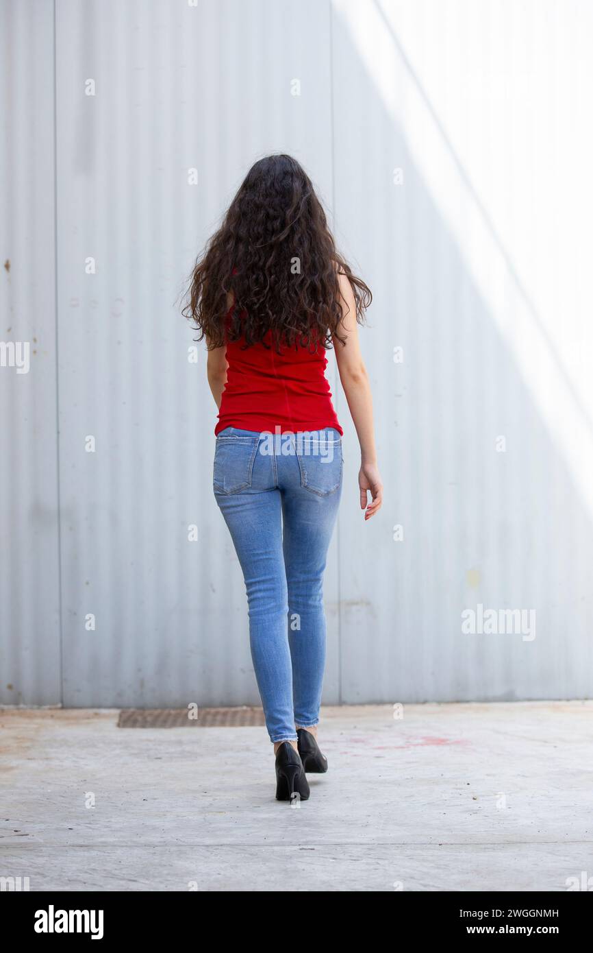 Full length rear view woman walking away outdoors Stock Photo - Alamy