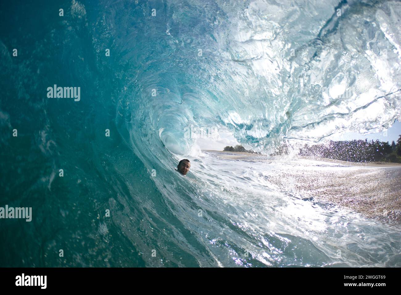 Man swimming inside tubing wave, Hawaii Stock Photo - Alamy