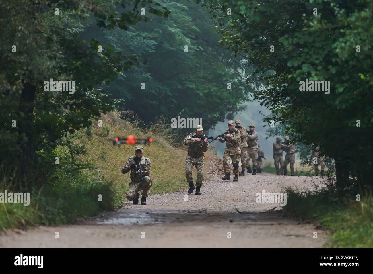 Elite military unit parading and securing the forest, utilizing drones ...