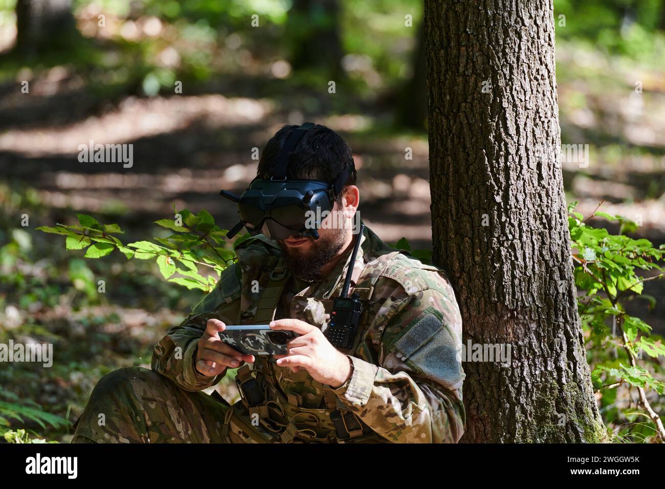 An elite soldier, equipped with state-of-the-art VR glasses, adeptly ...