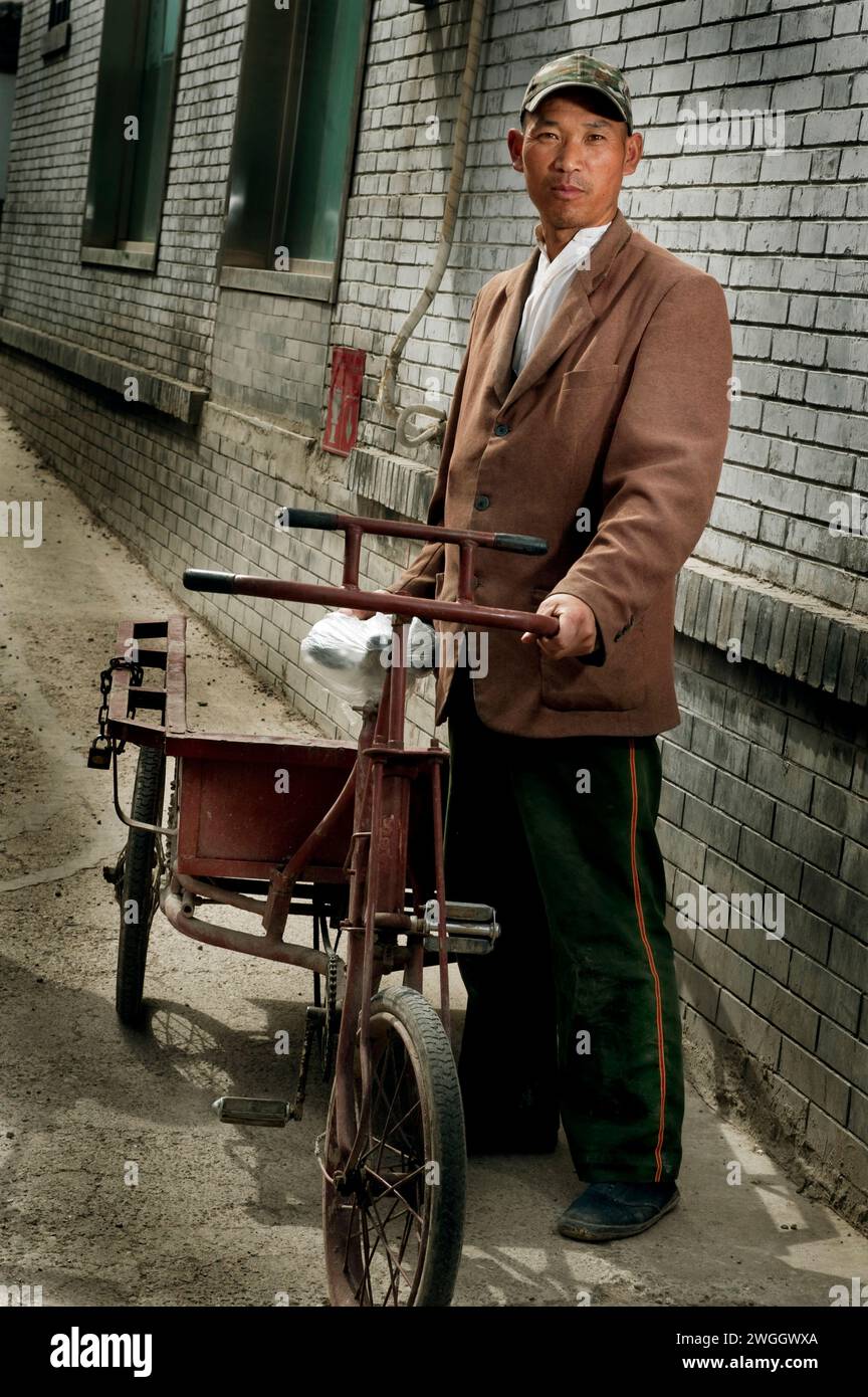 A chinese man with a bicycle Stock Photo - Alamy