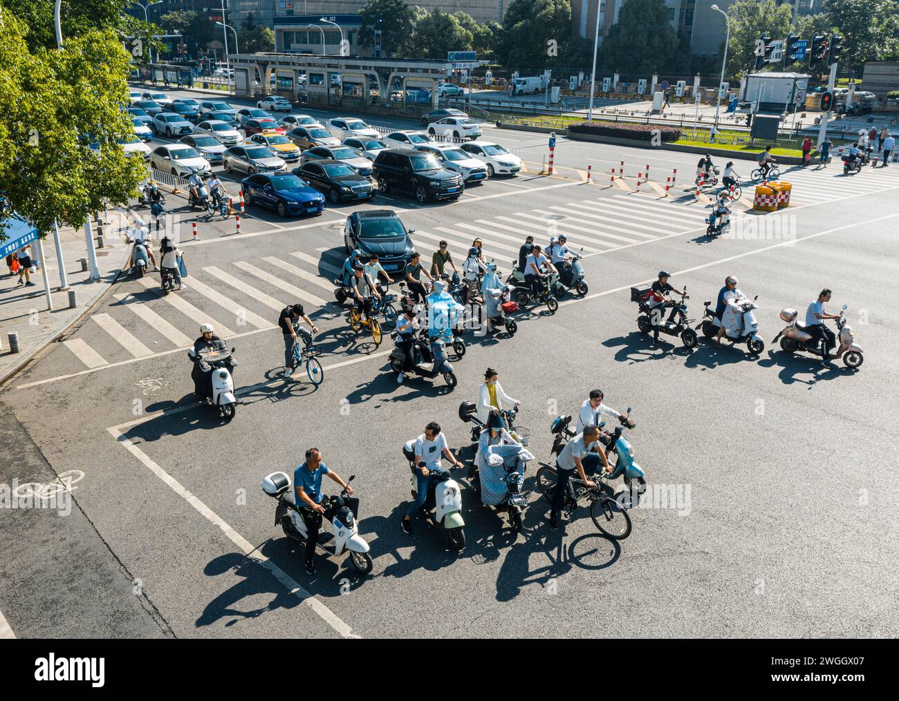 A bustling urban scene with a diverse group of people on motorcycles ...