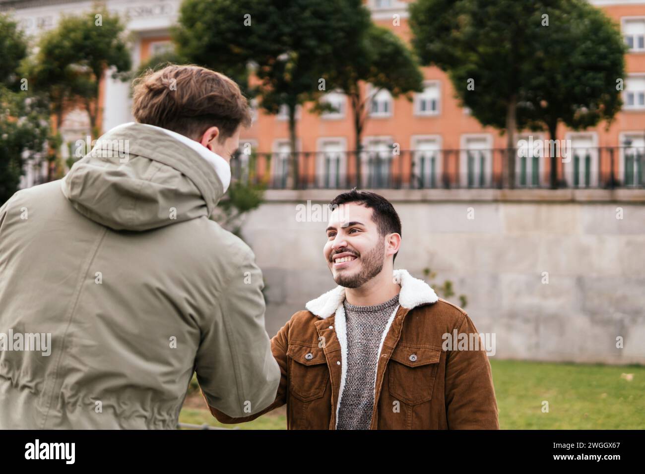 two boys shaking hands greeting each other Stock Photo - Alamy