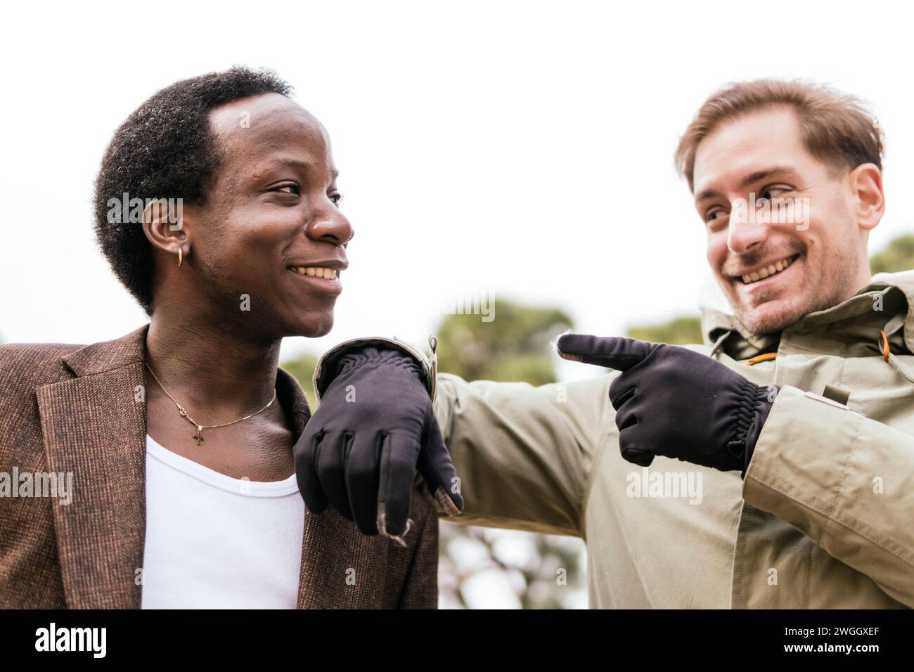 Two multiracial friends walking talking hi-res stock photography and ...