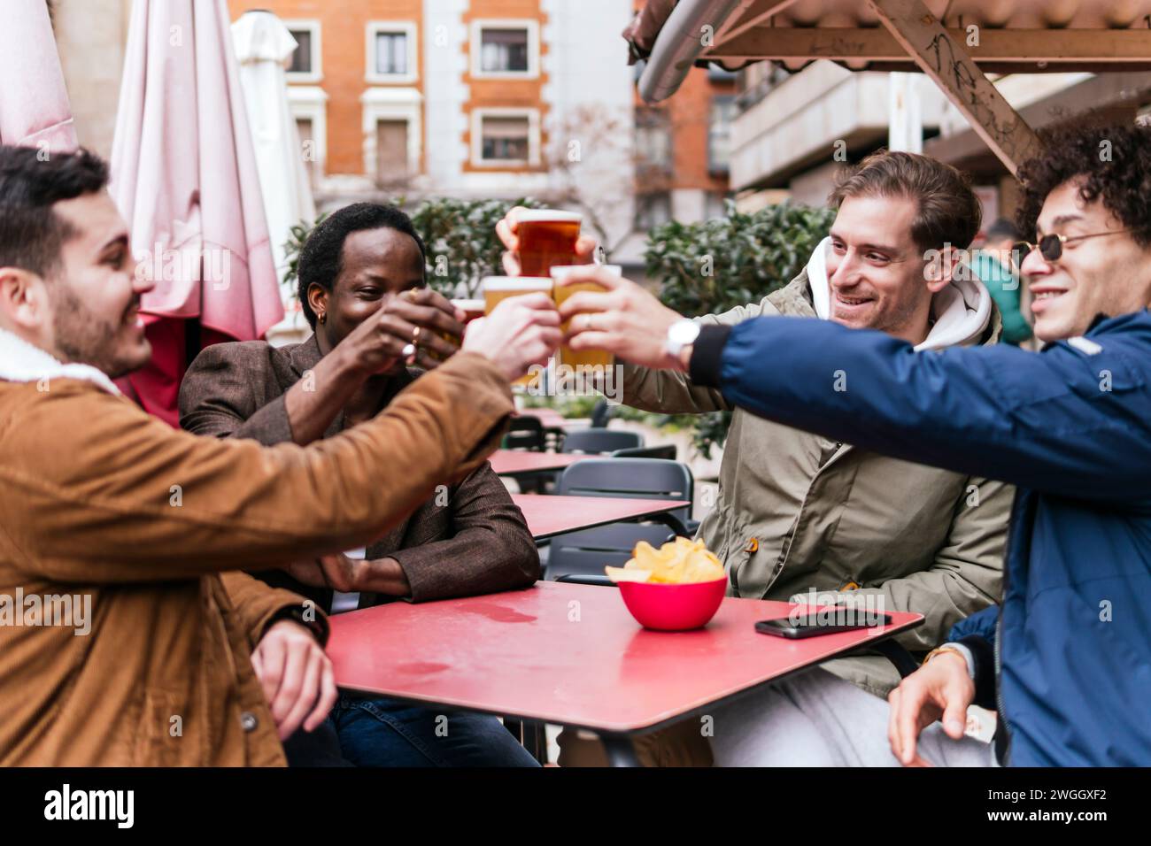 Happy multiracial young people talking hi-res stock photography and ...