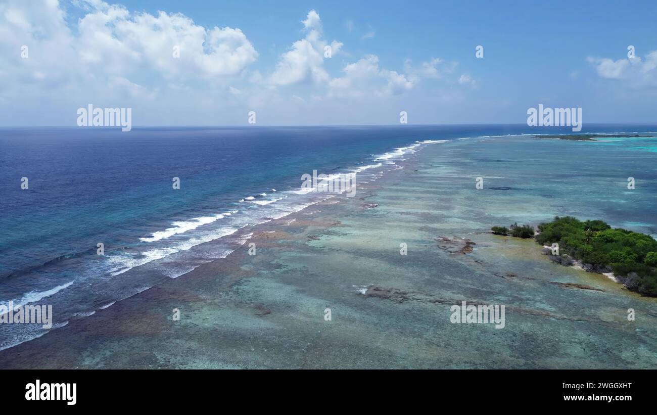 Drone view of paradise islands of the Maldives with coral reefs under ...