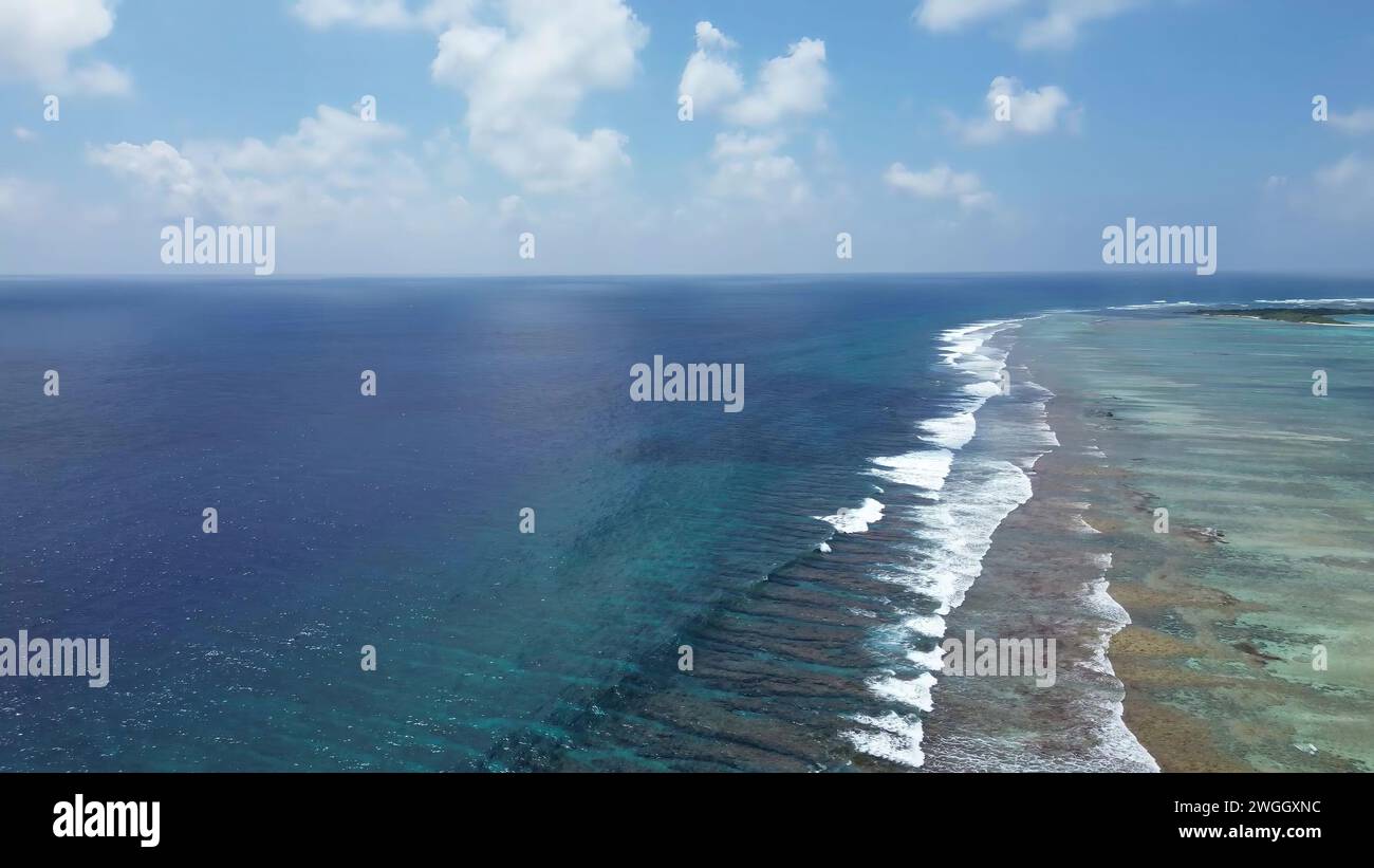 Drone view of paradise islands of the Maldives with coral reefs under ...