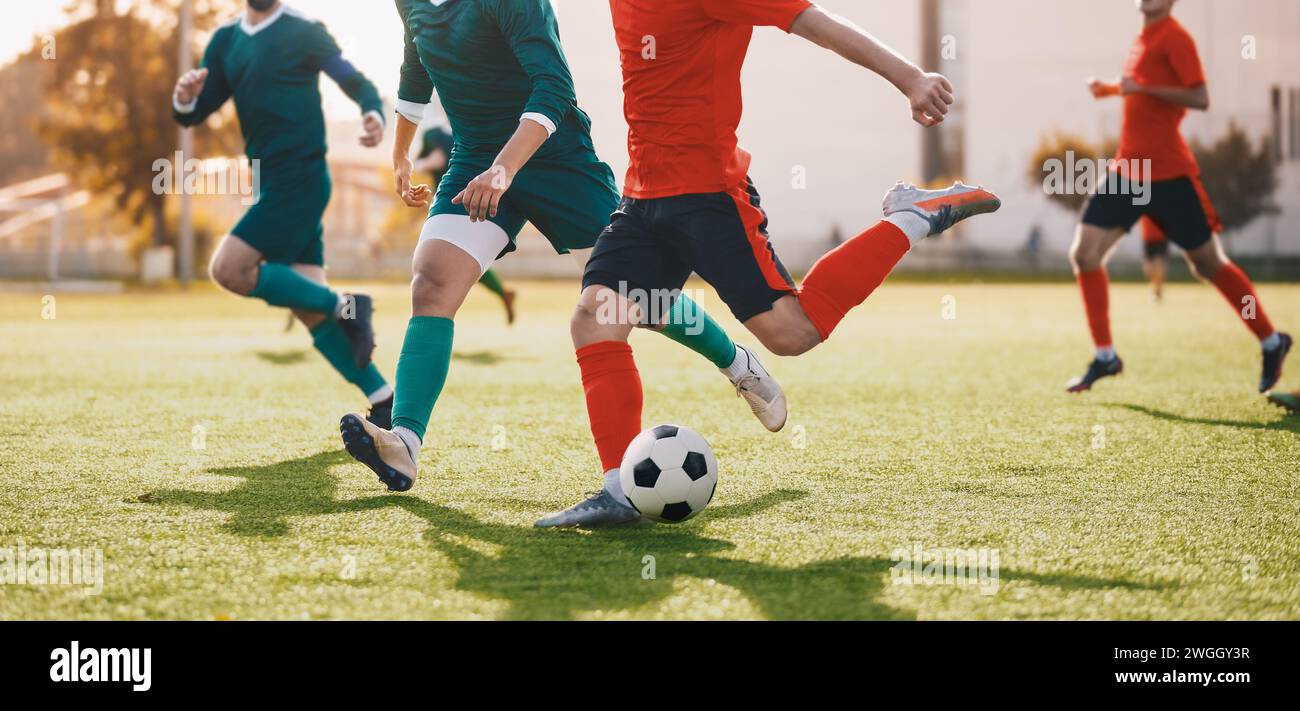 Adult Football Soccer Players Running with Ball. Footballers Kicking ...