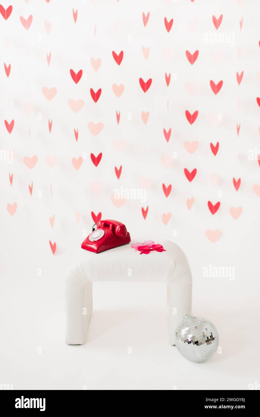 Rotary dial phone and disco ball against heart garland background Stock ...