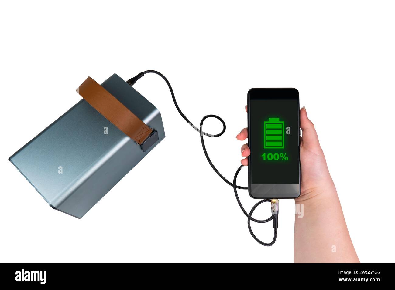 Smartphone in hand is charged from a power bank via a USB cable, on a ...