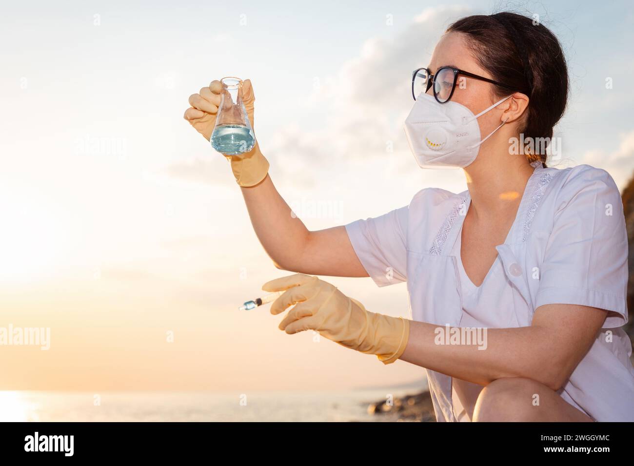 Side view of young woman scientist-ecologist wearing eyeglasses, mask ...